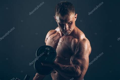 Muscle Man Doing Bicep Curls Stock Photo By Satyrenko