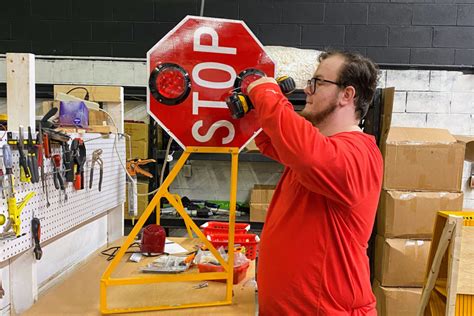 Bus Safety Solutions Technician Austin Leeland Assembles An Extended Stop Arm Davie County Blog