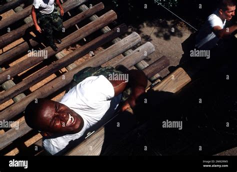 A Recruit Struggles To Climb A Tower On The Obstacle Course During A Recruit Struggles To Climb A Tower On The Obstacle Course During
