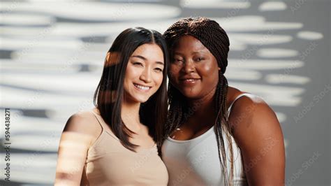 Confident Women Advertising Self Love And Bodycare Hugging Each Other In Studio And Showing