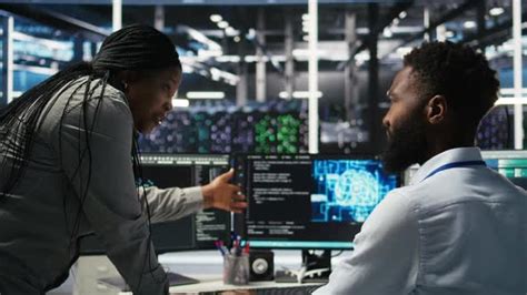 Data Center Supervisor Overseeing Work Done By Engineer Using Deep