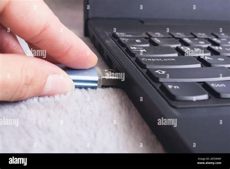 Hand Inserts A Usb Flash Drive Into The Laptop S Usb Connector Stock Photo Alamy
