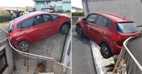 car stuck between two buildings after driver takes wrong turn