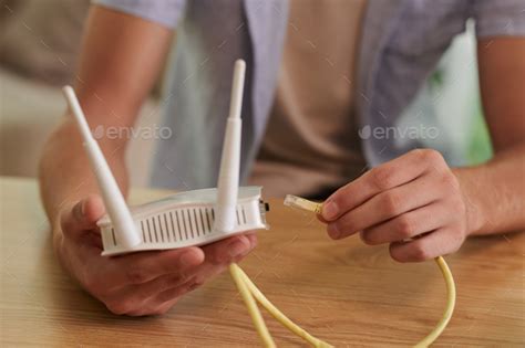 Inserting Ethernet Cord In Router Stock Photo By Dragonimages Photodune