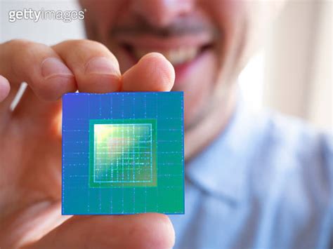 man presents a new microchip in his hand he holds a futuristic