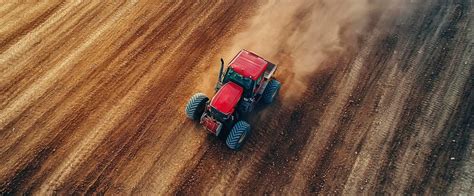 Aerial View Of A Red Tractor Working A Field Premium Ai Generated Image