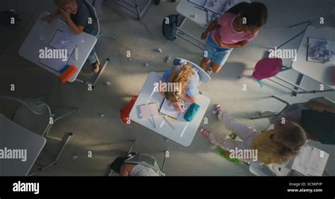 Classmates Bullying Sad Elementary School Girl Sitting At Desk And