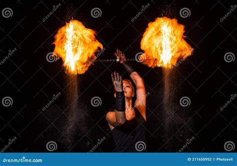 Sensual Fire Actress Manipulate Flaming Baton In Night Darkness Outdoors Theatre Stock Photo