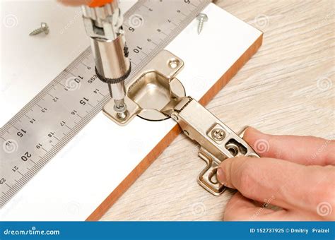 Furniture Loop Is Installed And Fixed On White Facade With Screwdriver