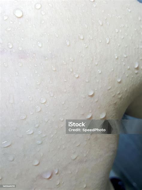 A Photography Of A Man With A Lot Of Water On His Back Man With A Wet