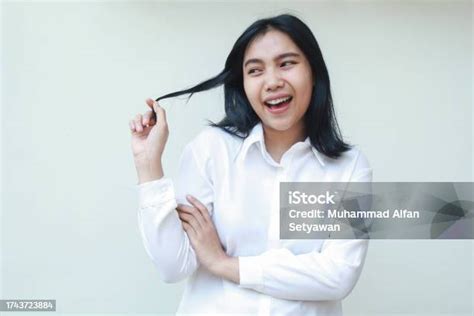 Portrait Of Carefree Asian Young Business Woman Grabbing Her Dark Hair