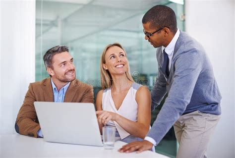 We Work Well Together Three Colleagues Working Together At A Laptop