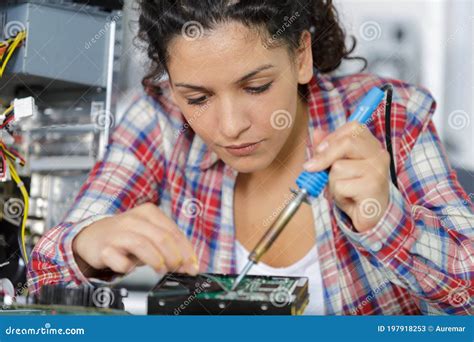 Female Electronic Engineer Checking Electronic Circuit In Laboratory
