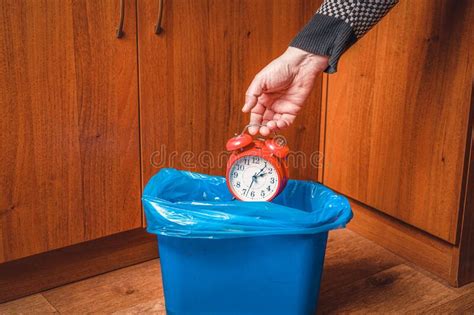 The Man Throws The Alarm Clock In The Trash Man S Hand With A Red Alarm Clock And A Trash Can