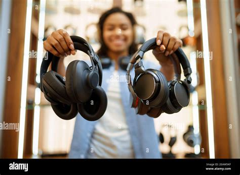 Woman Shows Headphones In Store Music Lover Stock Photo Alamy