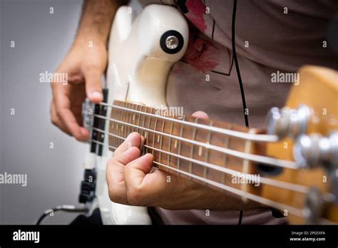 White Electric Bass In Musical Solo Showing In Detail The String Being