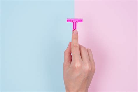 플랫 레이 평면 레이 상단 위에 높은 각도 위의 머리를 보기 밝은 분홍색 면도기를 사용 하 여 밝은 파스텔 배경에 고립 된 아름