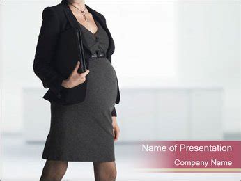 Pregnant Businesswoman Walking With A Folder In Midsection Against