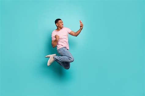 재미있는 행운의 남자 드레스 핑크 티셔츠 점프 독서 현대 장치 빈 공간 고립 된 청록색 배경의 전체 길이 사진 점프에 대한 스톡 사진 및 기타 이미지 Istock