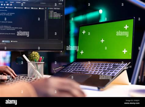 African American Programmer Working On Cloud Computing Next To Green Screen Writing Code For