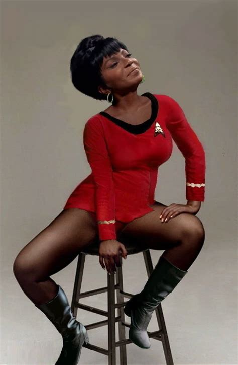A Woman Sitting On Top Of A Stool Wearing Boots And A Red Shirt With