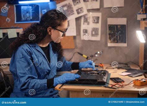 Female Technician Repairing Broken Laptop Notebook Computer With A Screwdriver In Retro Repair