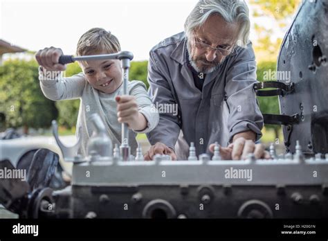 Senior Man And Babe Working On Mechanism Of A Car Stock Photo Alamy