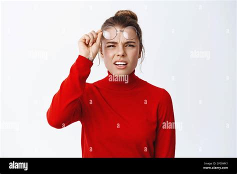 Image Of Confused Blond Girl Take Off Glasses And Squinting Trying To