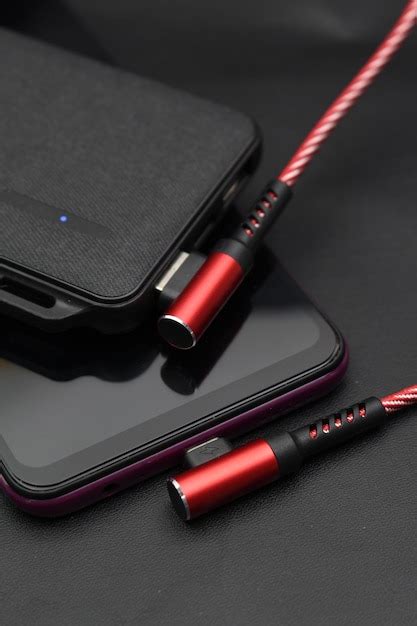 Premium Photo Red Data Cable With Powerbank And Smartphone