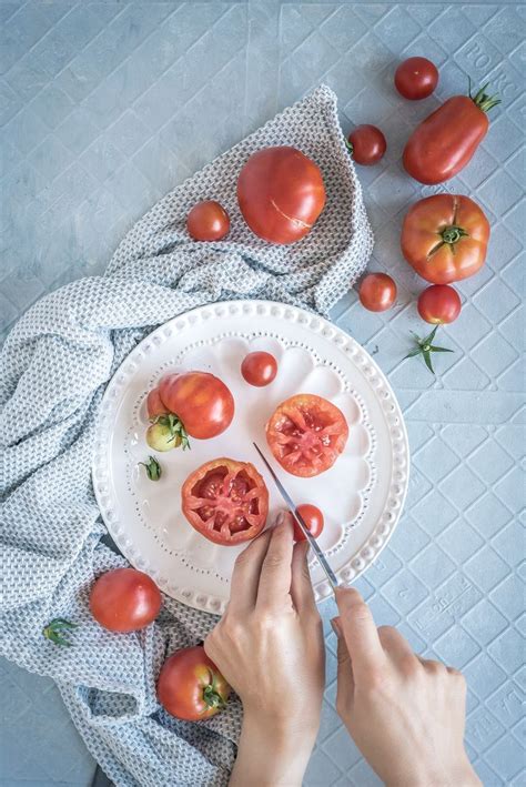 Slicing Tomatoes On A Grey And Blue Backdrop Healthylaura Food Photography Foodphotography