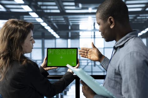 Computer Scientists In Data Center Use Mockup Tablet To Calibrate Energy Usage Stock Image