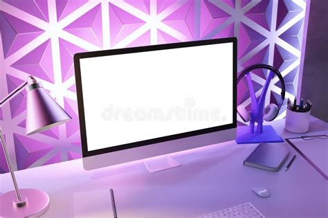 a modern workspace with computer screen headphones desk lamp and