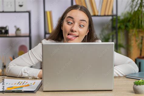 Caucasian Business Woman Hiding Behind Laptop Computer Making Funny Face Fooling Around