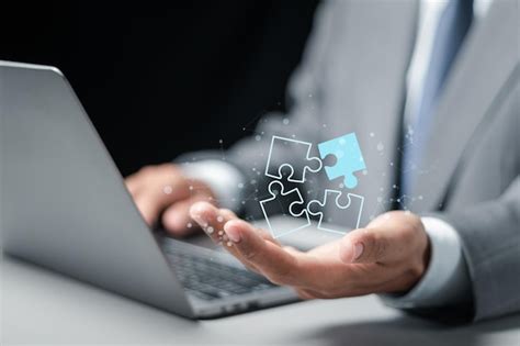 Premium Photo Business Teamwork Concept Businessman Holding Jigsaw Puzzle Icon In Hand