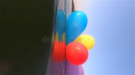 bunch multi colored balloons tied ribbon floating surface sea water