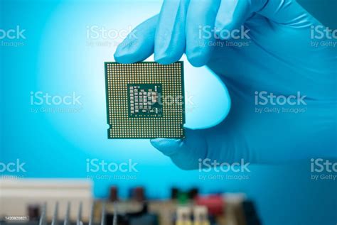 Electronic Engineer Hand Holding Computer Chip On Blue Background Chipset Of Electronic Circuit