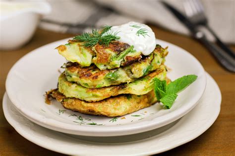 적절 한 영양 채식 아침 식사 글루텐 프리 호박은 콩으로 만든 팬케이크 맛 있는 그리스어 Yougurt와 흰 접시에 민트 검은 배경 수건 포크 나무 표면에 나이프 건강한