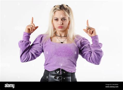 Blonde Millennial Woman Wearing Ribbed Blouse Standing Isolated Over