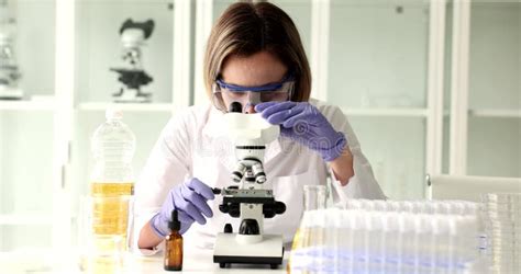Laboratory Worker Examines Oil Sample Through Microscope Stock Video Laboratory Worker Examines Oil Sample Through Microscope Stock Video