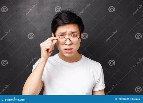 Close Up Portrait Of Arrogant Skeptical Asian Man In White T Shirt