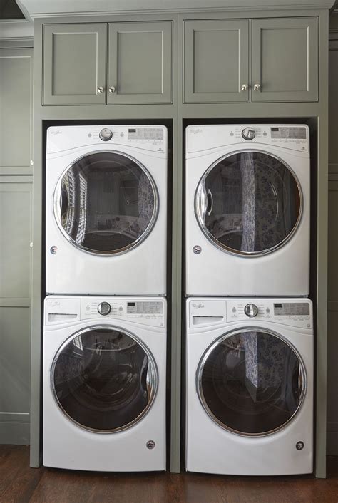 Set Of Two Washer And Dryer Stacked With Green Cabinets Laundry Room