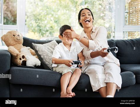 Mother And Son Playing Video Games Having Fun And Enjoying Quality