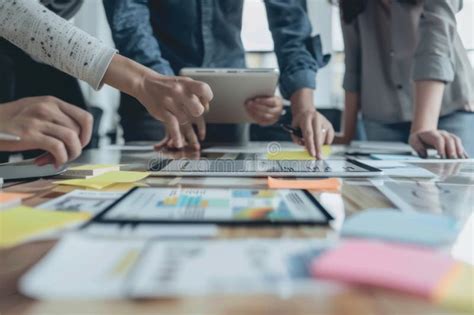 Team Collaborating On A Project Analyzing Data On Tablets And