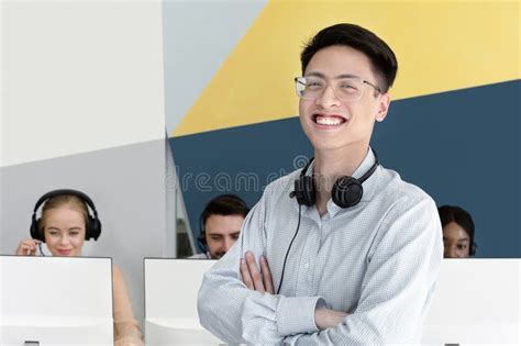 Asian Male Tech Support Operator Posing With Crossed Arms At Call