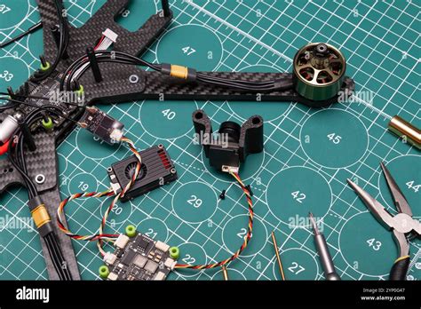 Disassembled Sport Fpv Drone Body With An Electric Motor Lies On A Work Table Alongside Diy