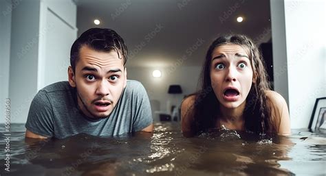There Is A Flood In The Apartment A Babe Couple In Shock Stands In An Apartment Waist Deep In
