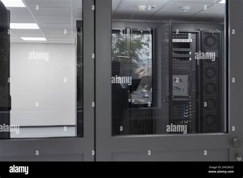 Software Engineer Working On A Laptop Computer In A Modern Server Room