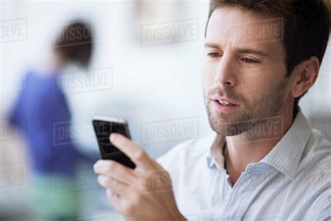 Mid Adult Man Checking Cell Phone Royalty Free Stock Photo Dissolve