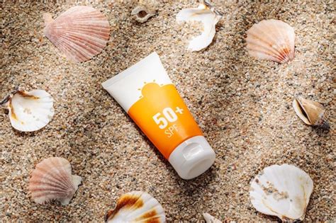 Premium Photo Orange Tube Of Sunscreen On Sandy Beach Top View