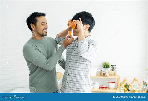 Gay LGBT Sweet Happy Asian Couple Wearing Pajamas Smiling Taking Care Teasing With Piece